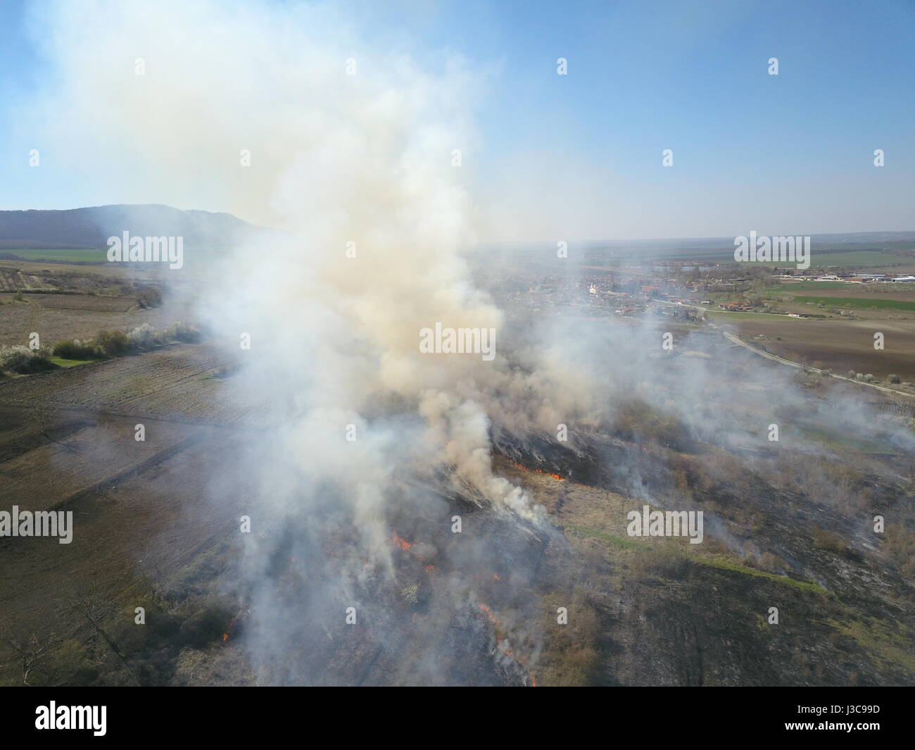 Fire burns in the forest above a village of Bozveliisko, some 60 km ...