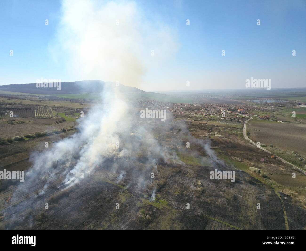 Fire burns in the forest above a village of Bozveliisko, some 60 km ...