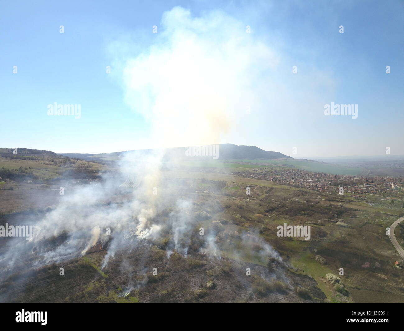 Fire burns in the forest above a village of Bozveliisko, some 60 km ...