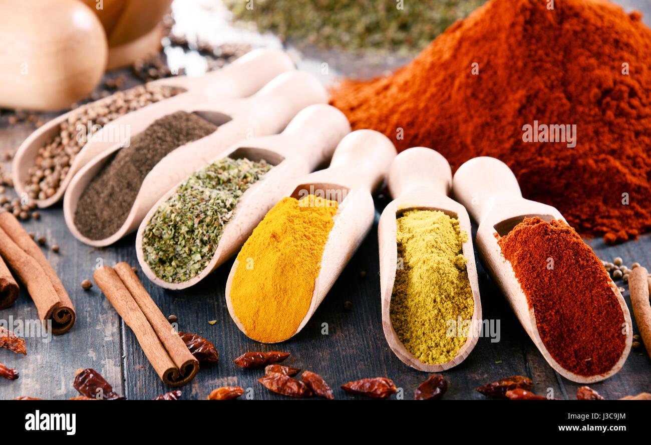 Variety of spices on kitchen table Stock Photo - Alamy