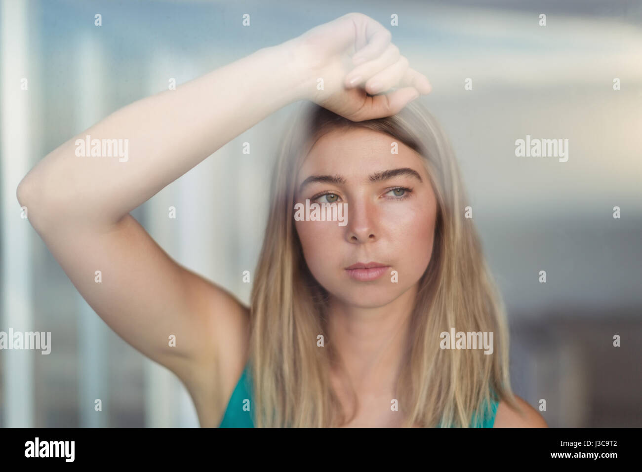 Thoughtful woman leaning on window at home Stock Photo - Alamy