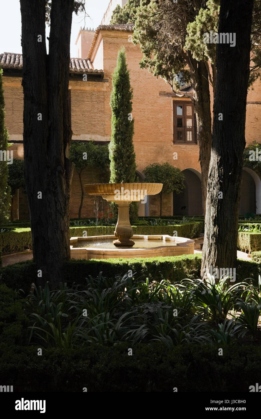 Water fountain in an ornamental garden on the Alhambra palace grounds ...