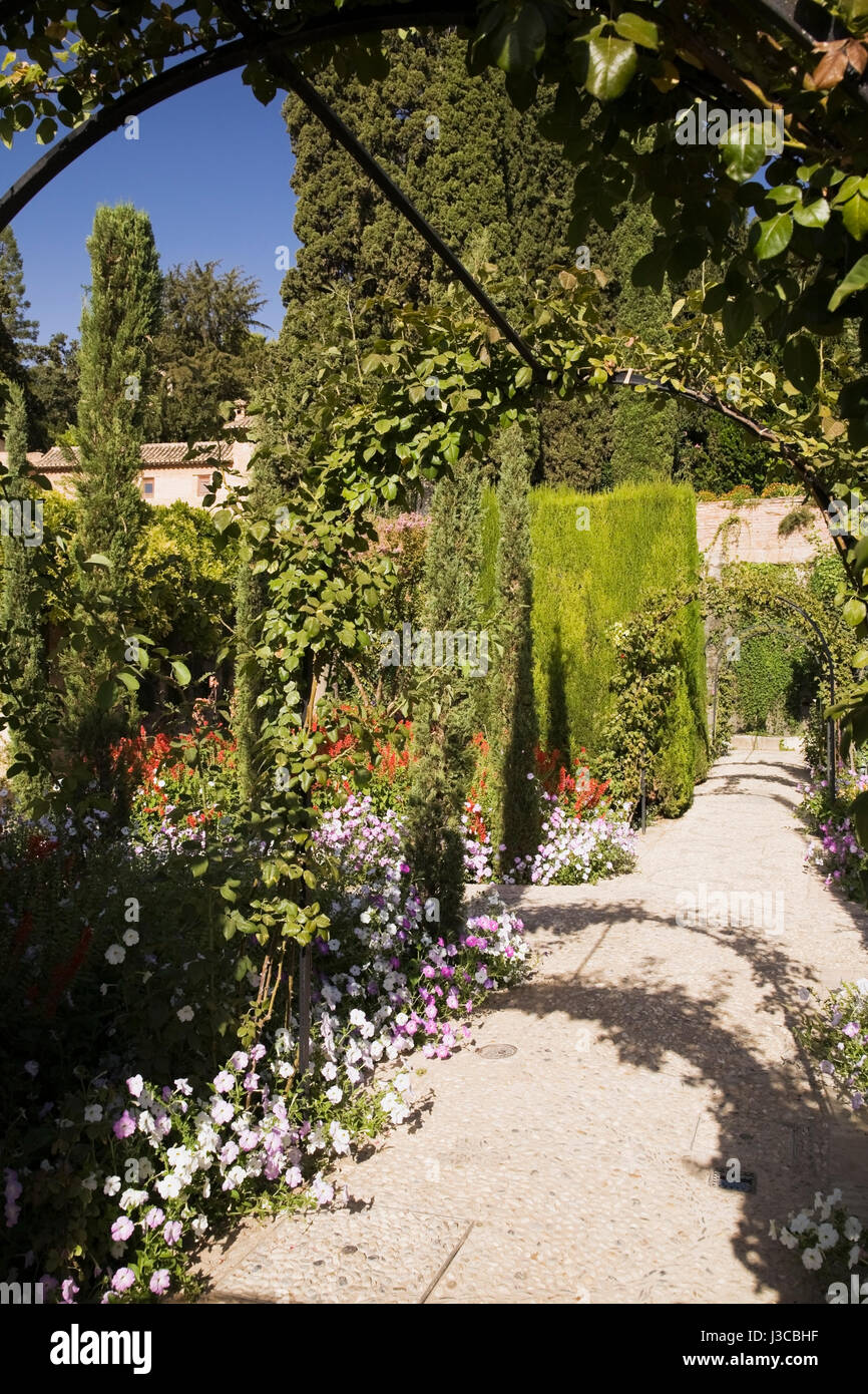 Paved walking path made of pebbles in an ornamental garden on the ...