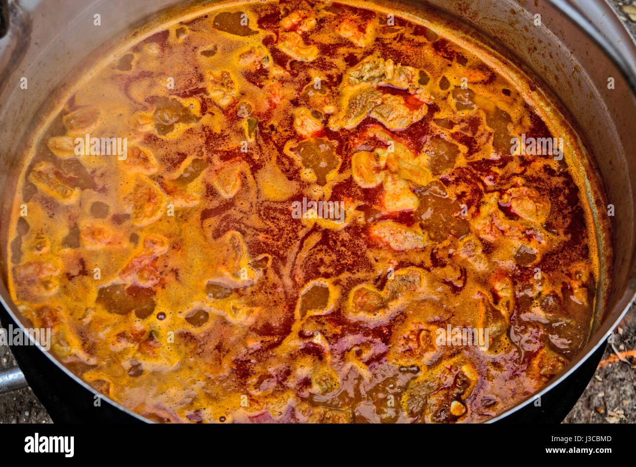Cooking traditional stew in a kettle outdoors Stock Photo - Alamy