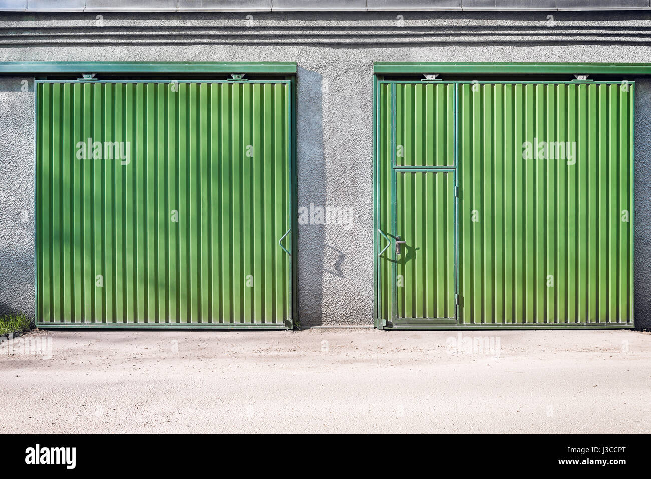 Metal green gates and door of the big storage Stock Photo - Alamy