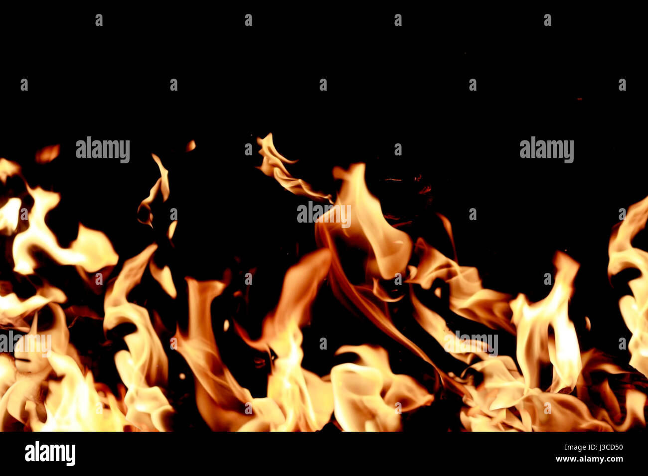 Intense fire isolated over black background Stock Photo - Alamy