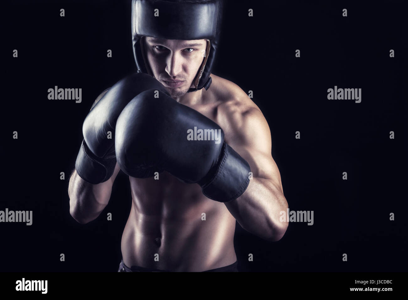 Boxer with an aggressive look with boxing gloves before a fight on a ...