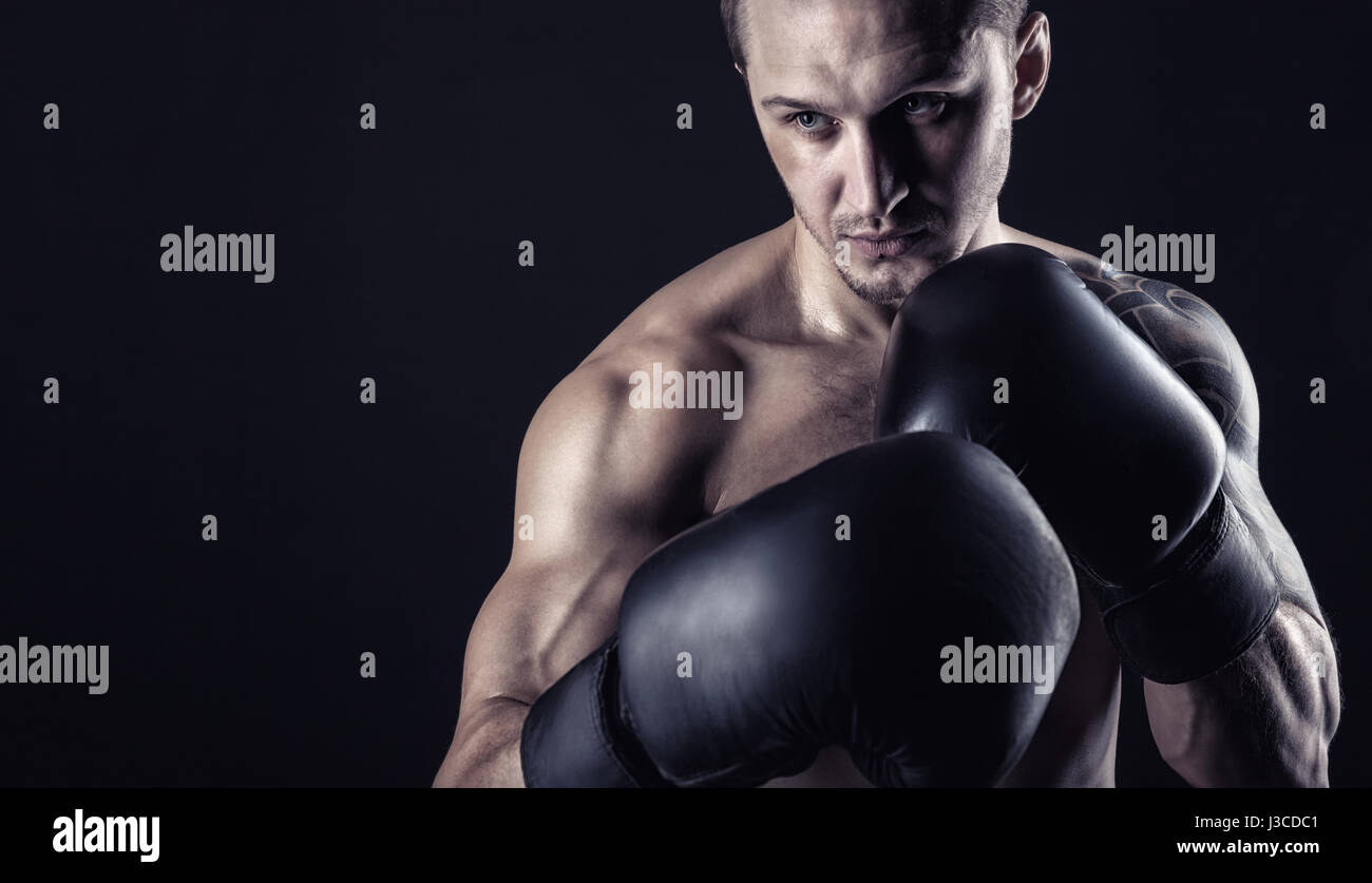 Boxer with boxing gloves before a fight on a black background. Boxing ...