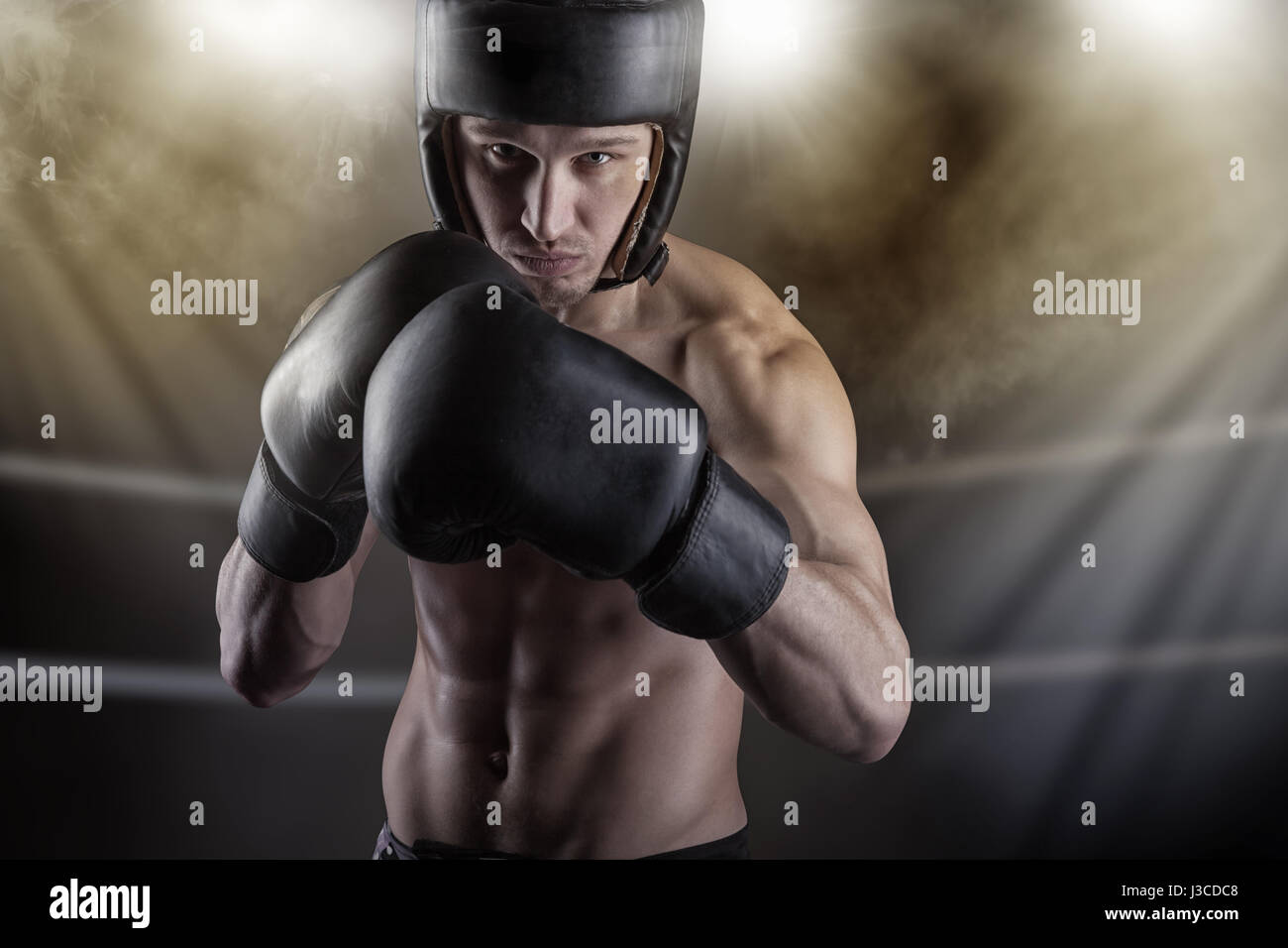 Boxer with an aggressive appearance with boxing gloves in the ring ...