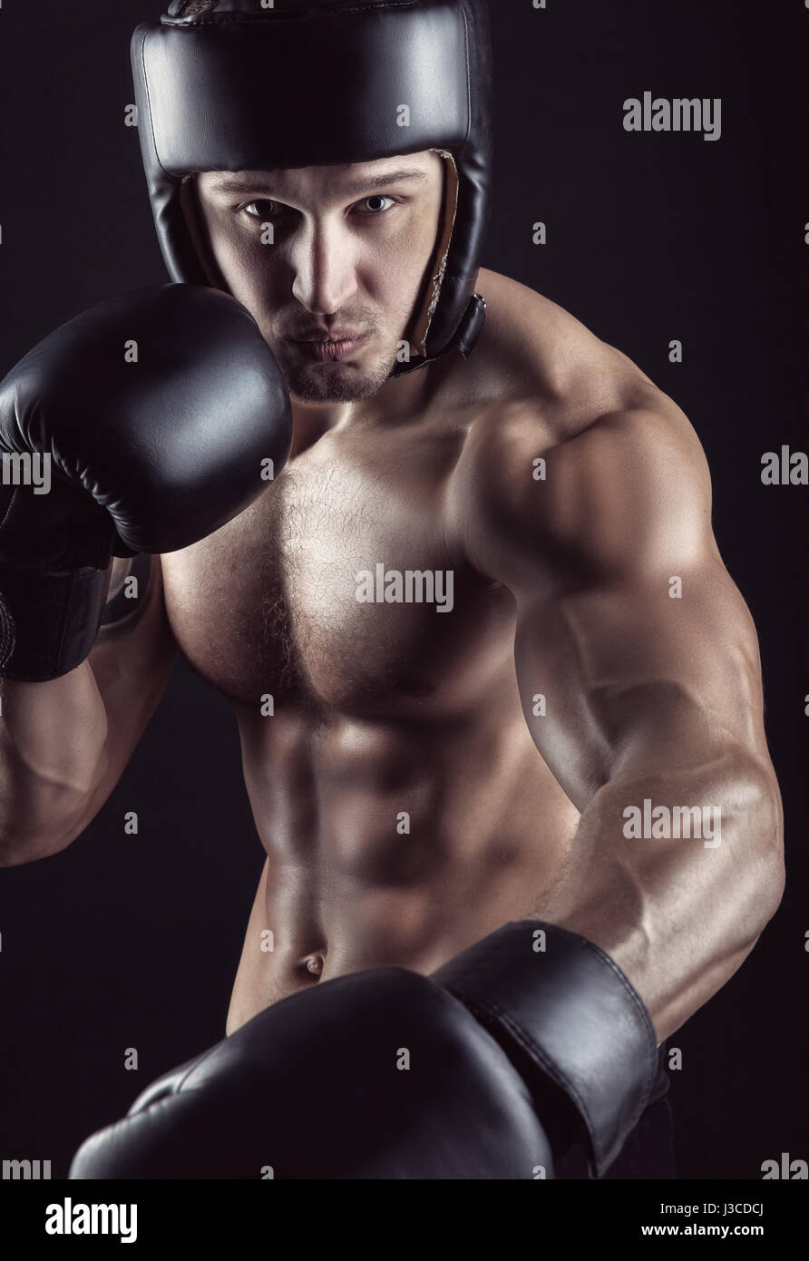 Boxing concept. Boxer with an aggressive look with boxing gloves before ...
