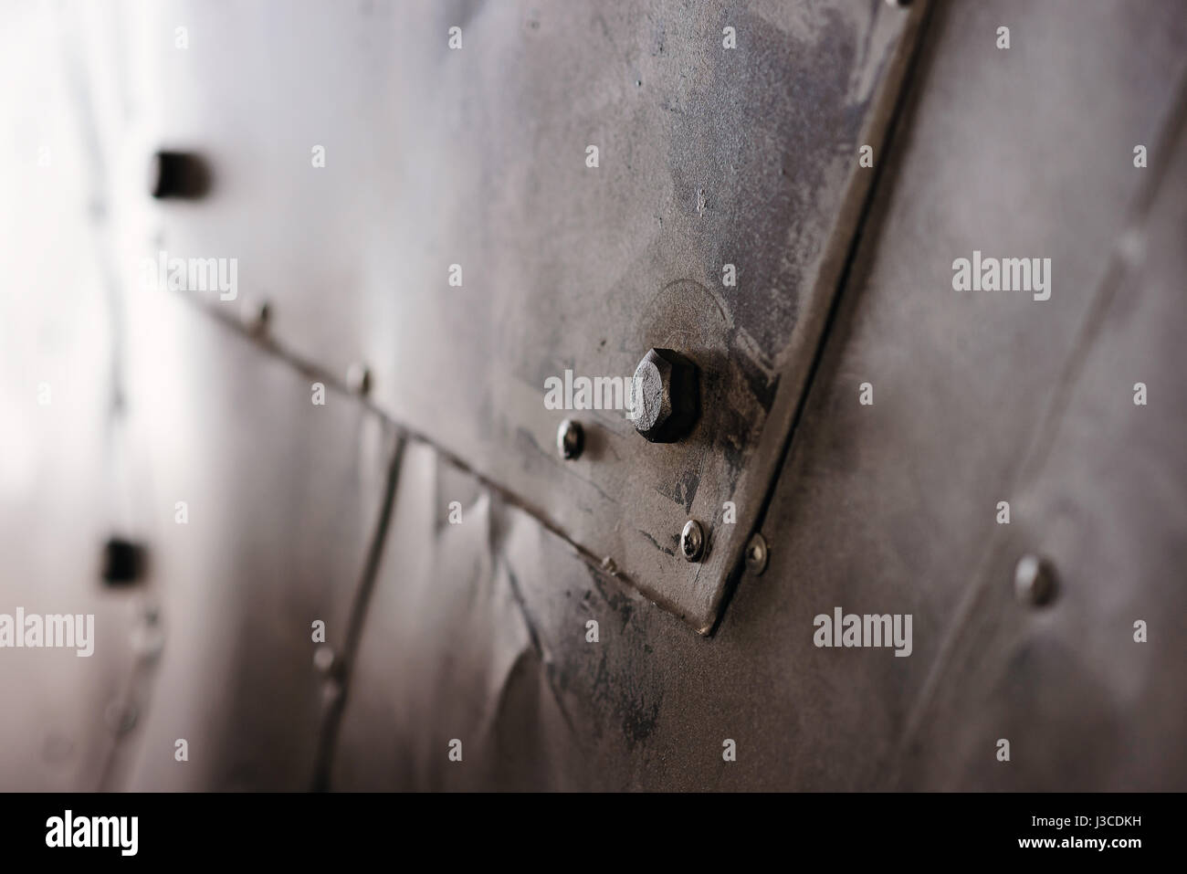 Metallic golden block tile with bolts floor reflecting bright light ...