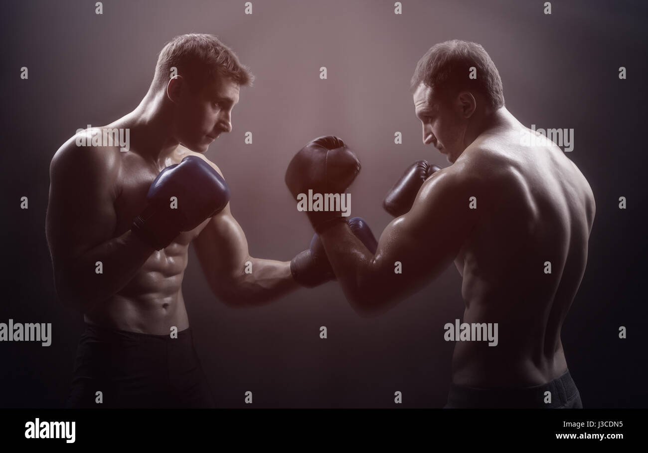Two boxer with boxing gloves before a fight on a black background Stock ...