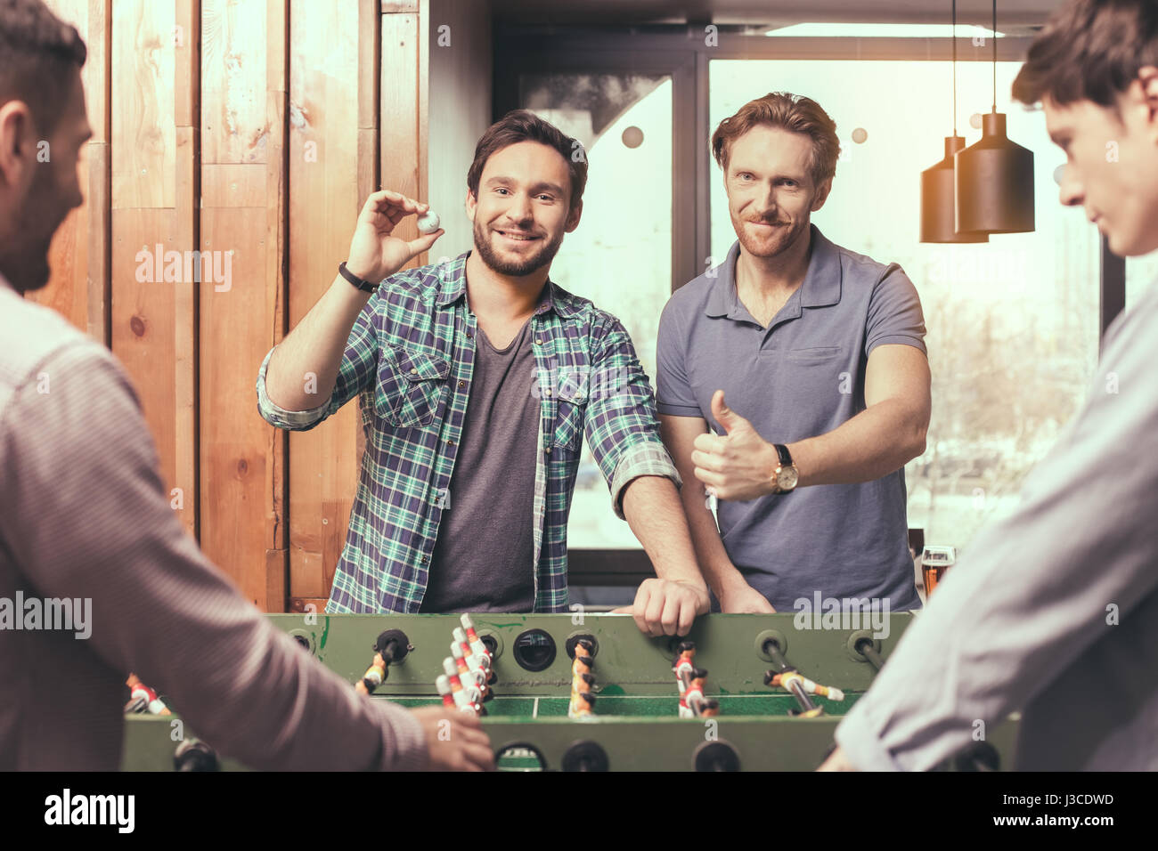 Friends having fun in pub Stock Photo - Alamy