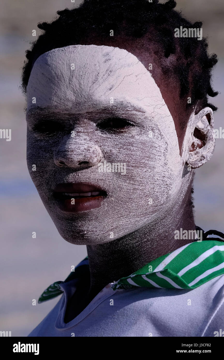 A young Mwani woman with her face covered with a natural white mask to ...