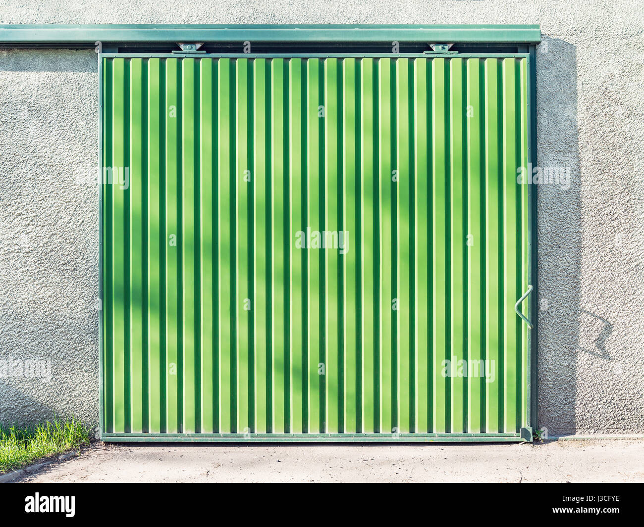 Metal green gate of the big storage Stock Photo - Alamy