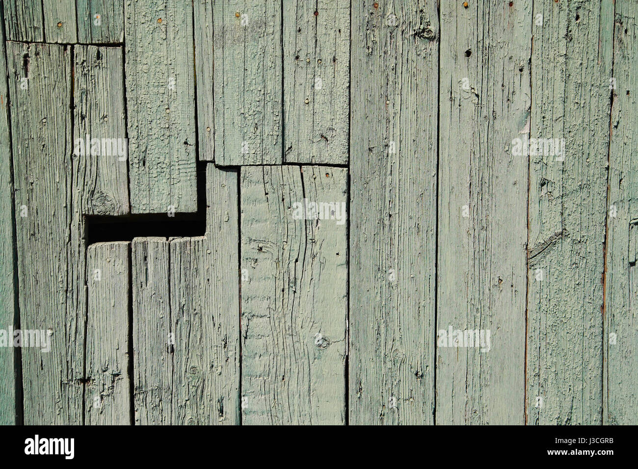 Old wooden fence with a post hole for newspapers and letters Stock ...