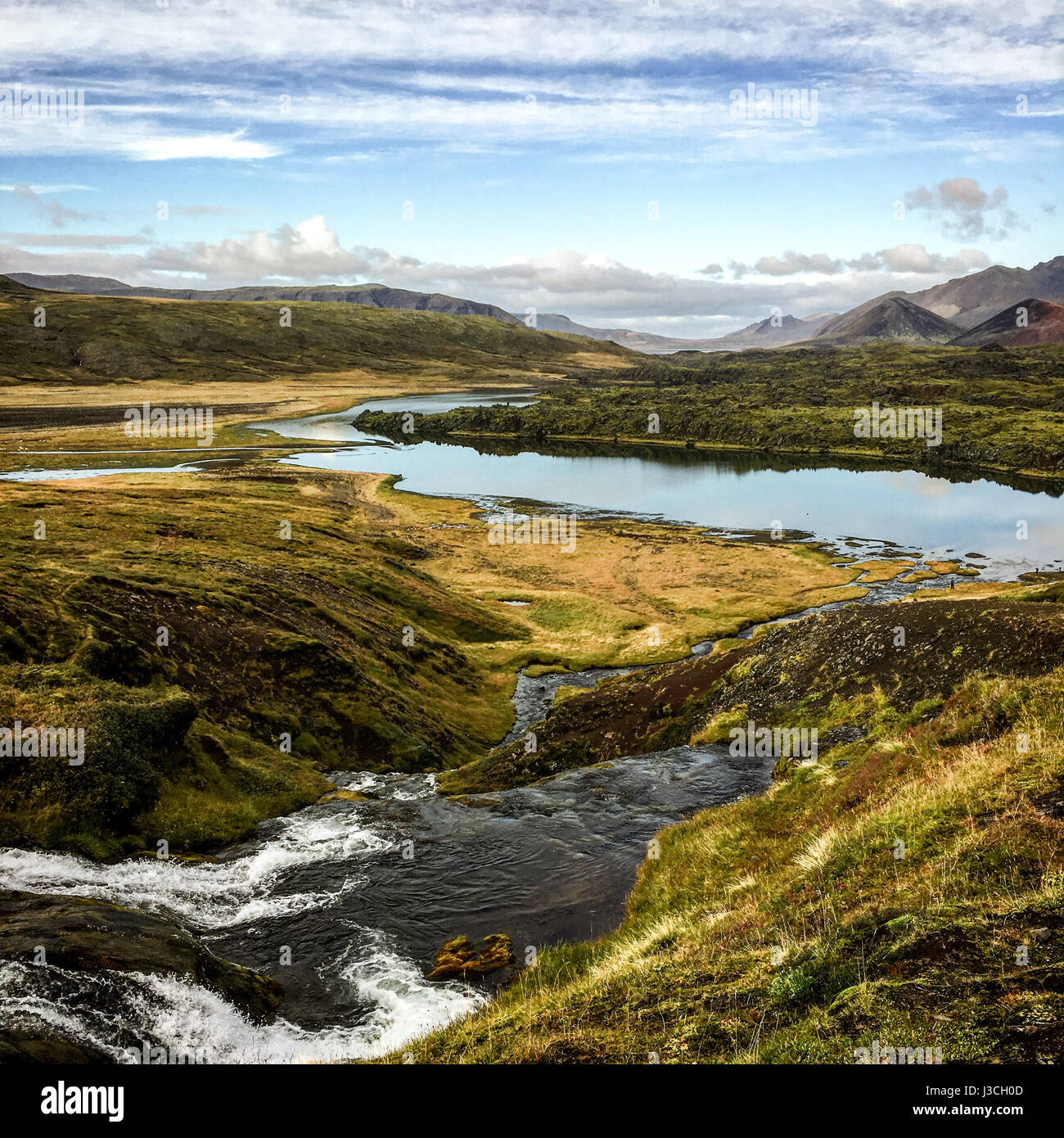 Cold water in Iceland. Stream in rocky mountains and lake side. Fresh ...