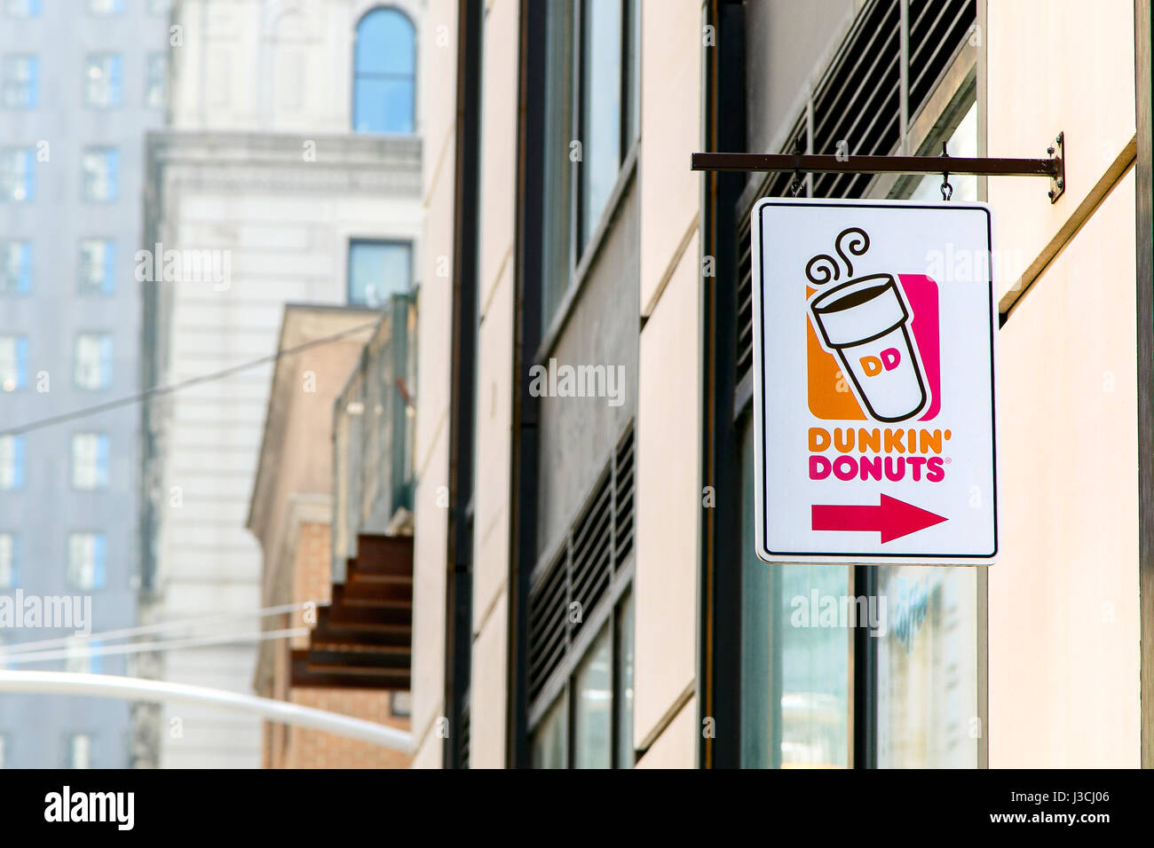 A sign over an entrance to a Dunkin Donuts location in Manhattan Stock ...