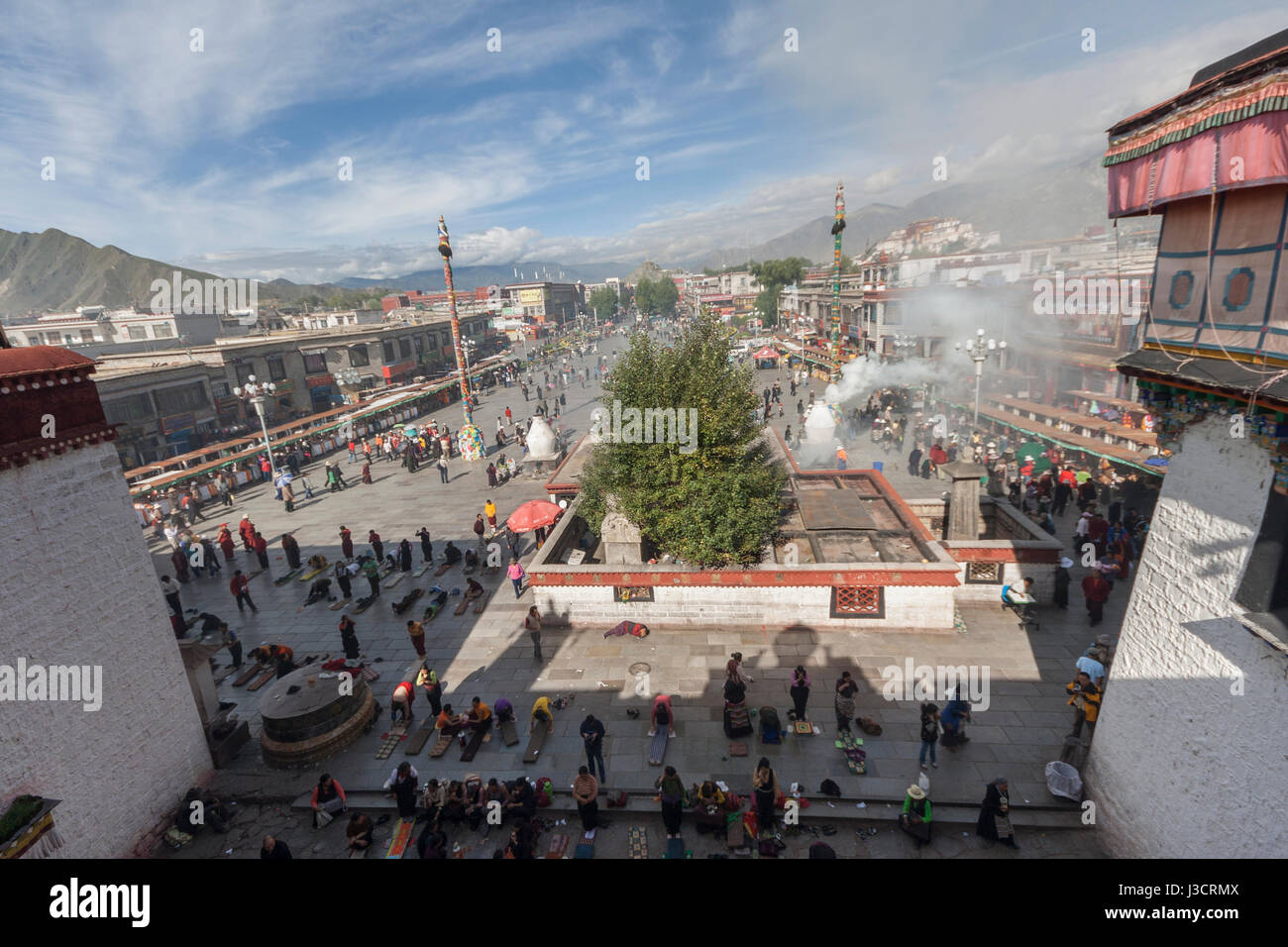 Morning view of crowded Barkhor square filled with juniper smoke, Lhasa ...