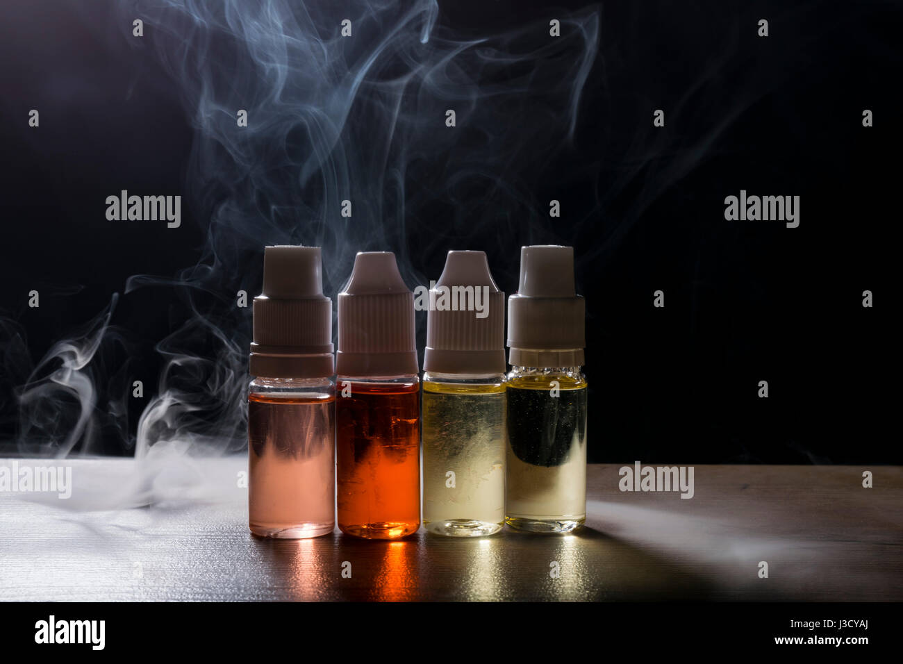 isolated e liquid for electronic cigarette with smoke background Stock ...