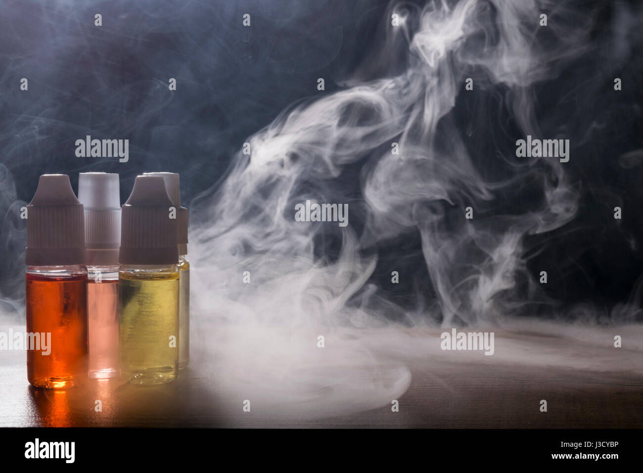 isolated vape e liquid for electronic cigarette on a dark background ...