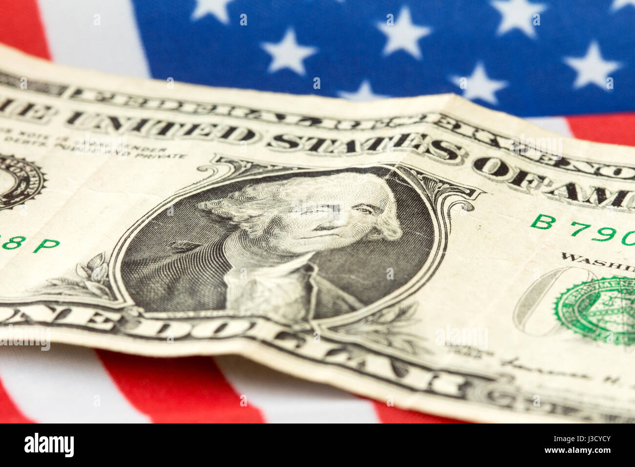 One Dollar banknote (USD) currency money over the flag of the United ...