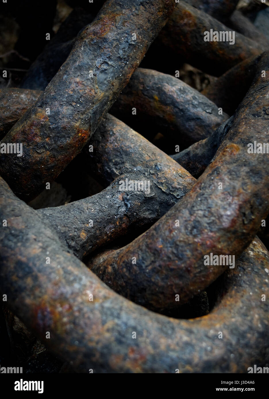 Backgrounds and textures: links of old black rusty chain, close-up shot ...