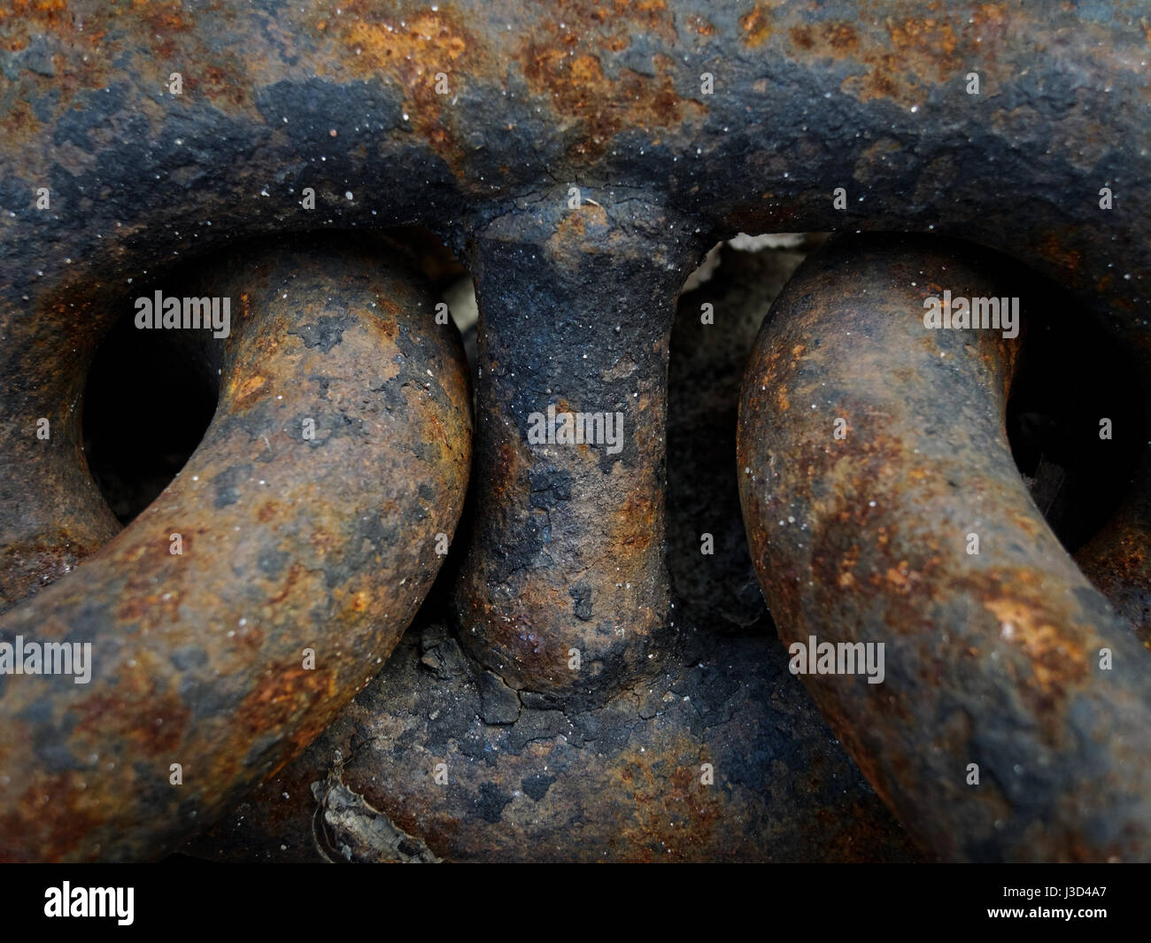 Backgrounds and textures: links of old black rusty chain, close-up shot ...