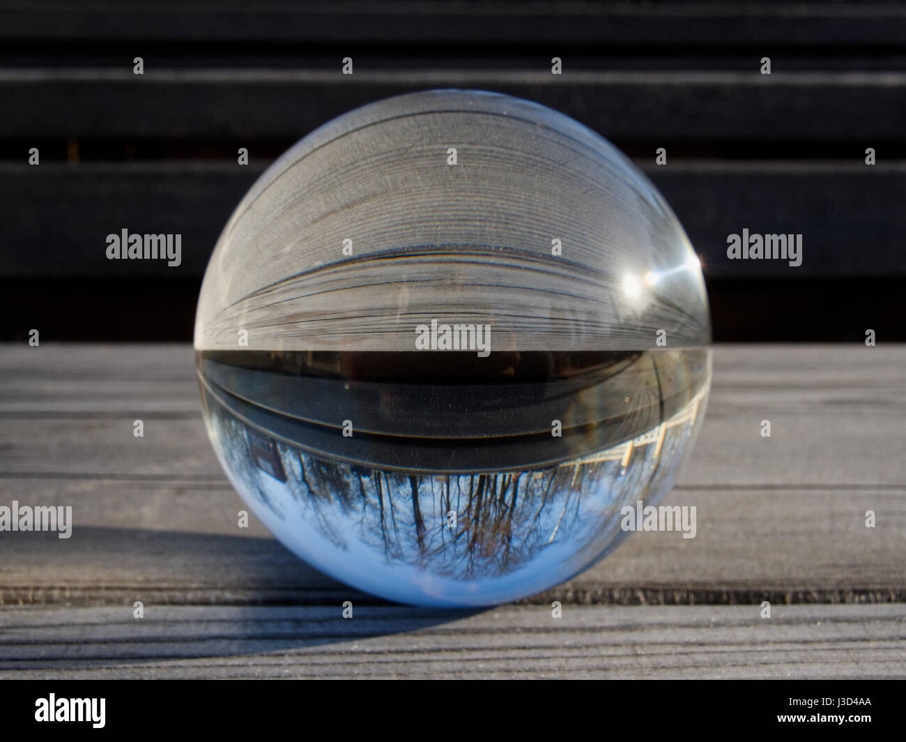 Backgrounds and textures: glass ball on a wooden table, part of a ...
