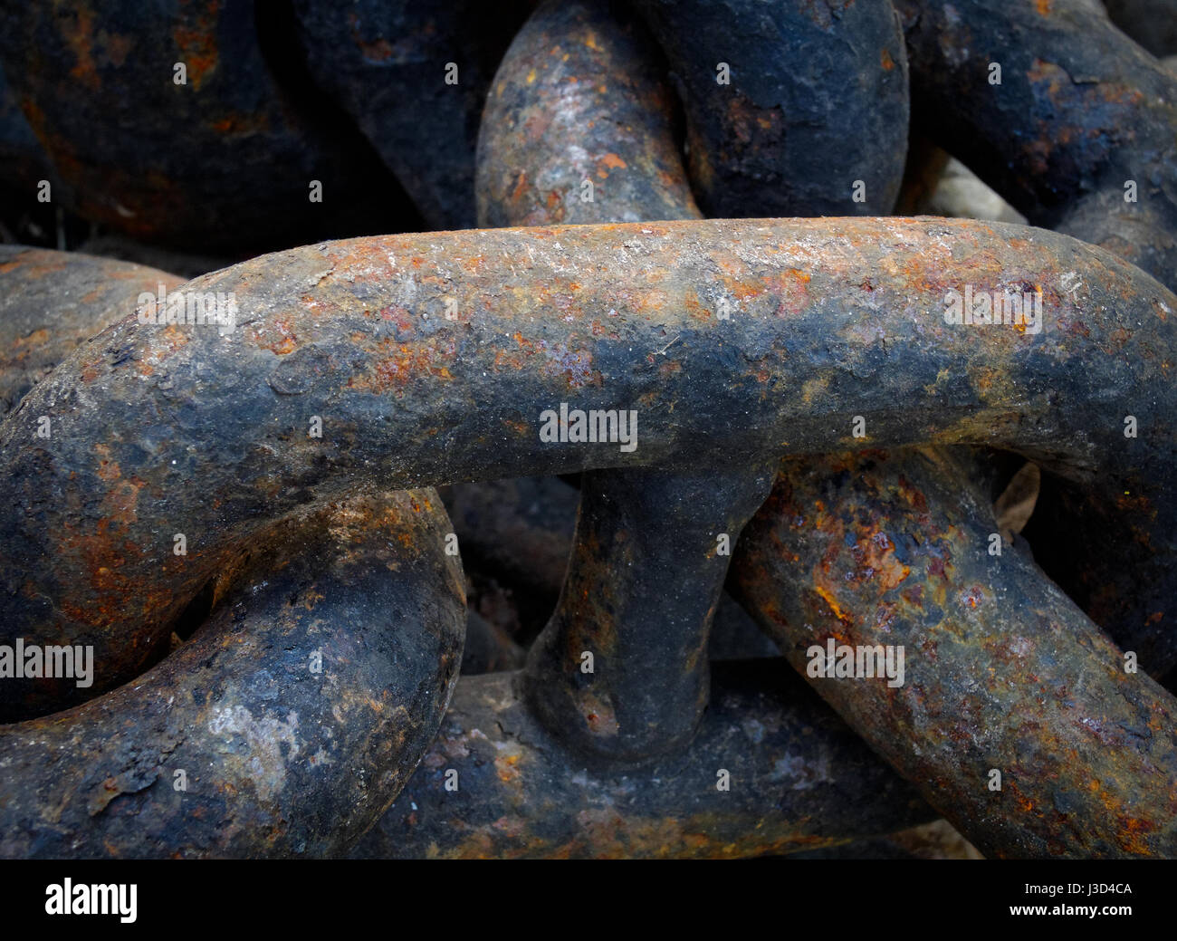 Backgrounds and textures: links of old black rusty chain, close-up shot ...