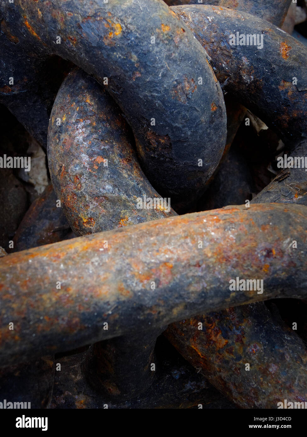 Backgrounds and textures: links of old black rusty chain, close-up shot ...