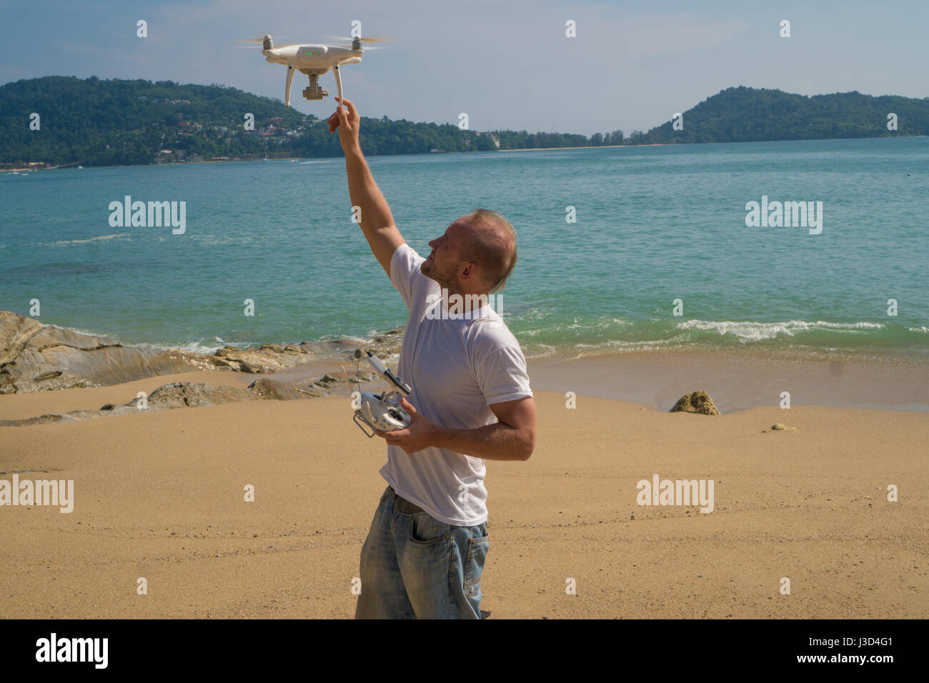 Man standing coast flying drone hi-res stock photography and images - Alamy