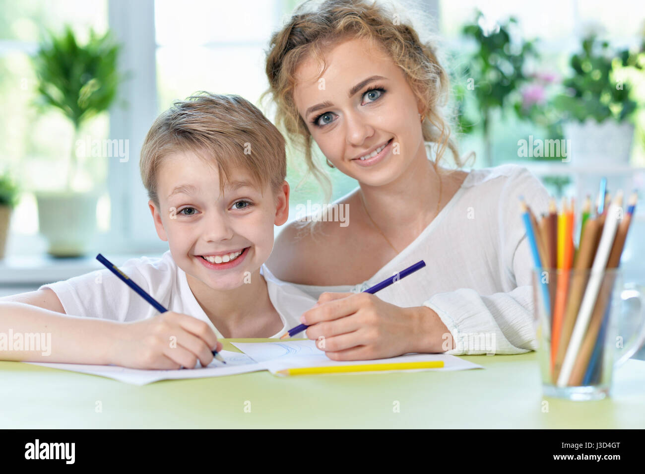 Mom and son doing lessons Stock Photo - Alamy