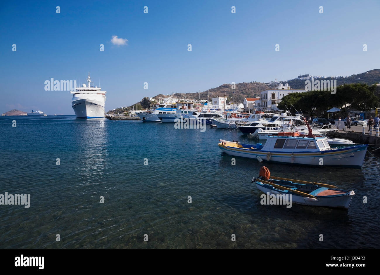 Small boats and luxury cruise ships anchored in the Port of Patmos ...