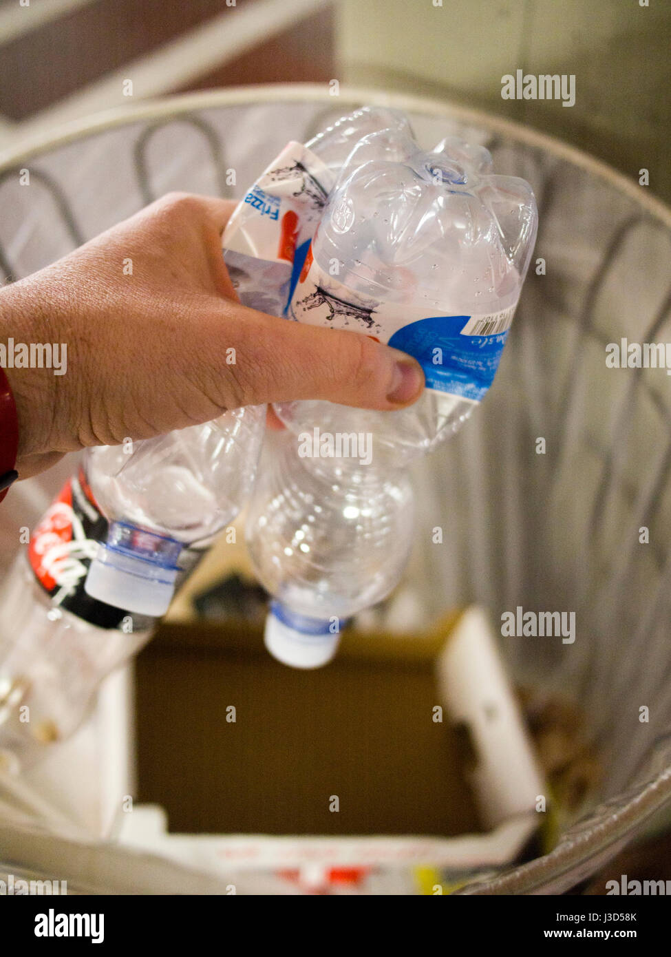 Putting plastic waste in the mixed trashcan Stock Photo - Alamy