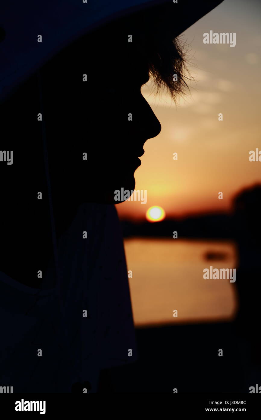 Silhouette of a boy backlit Stock Photo - Alamy