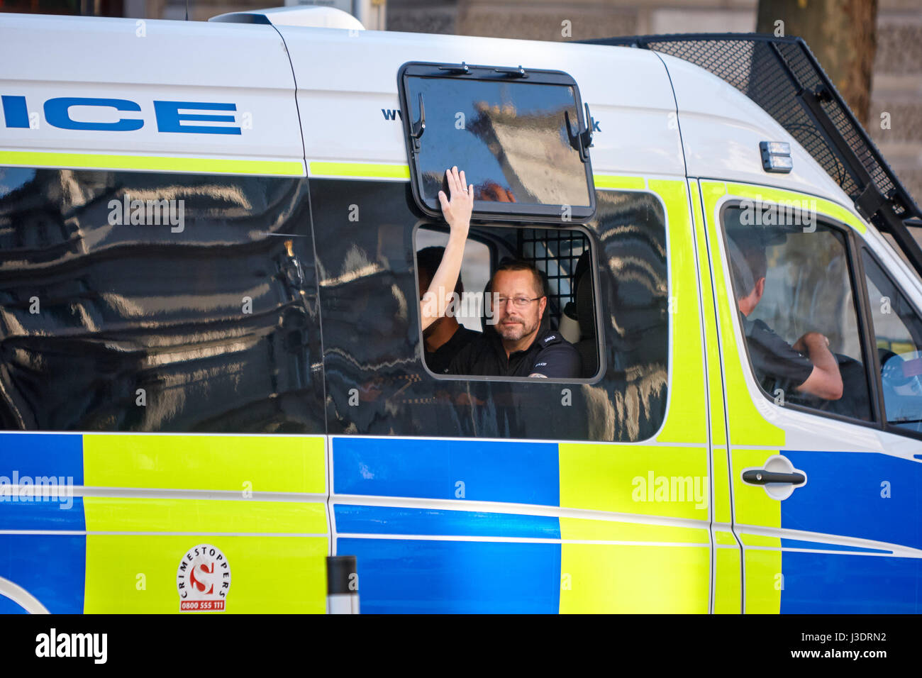 Police officer looks through the window of a police van Stock Photo - Alamy
