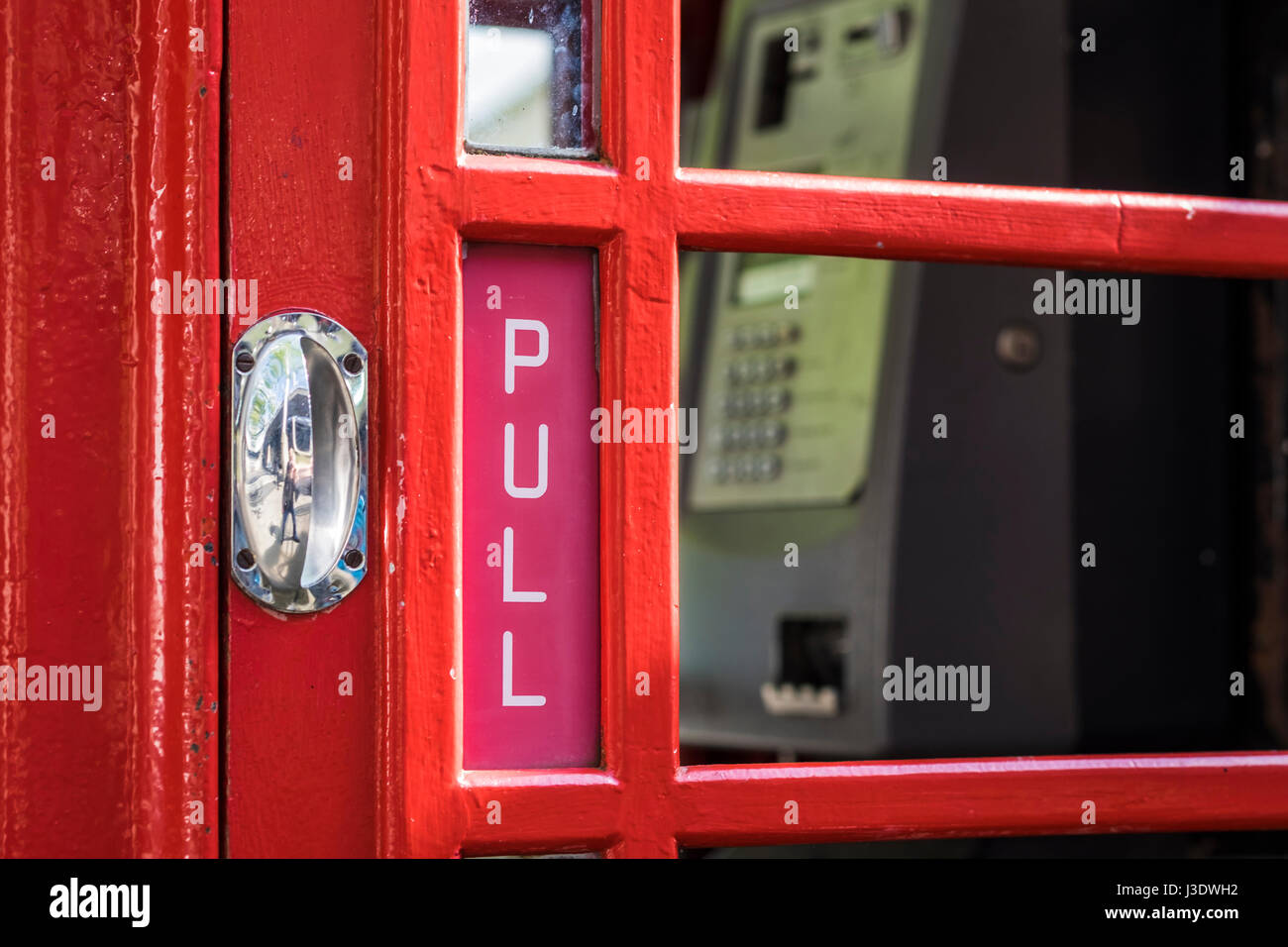 Pull handle on the door of a red telephone box, London, England, U.K ...