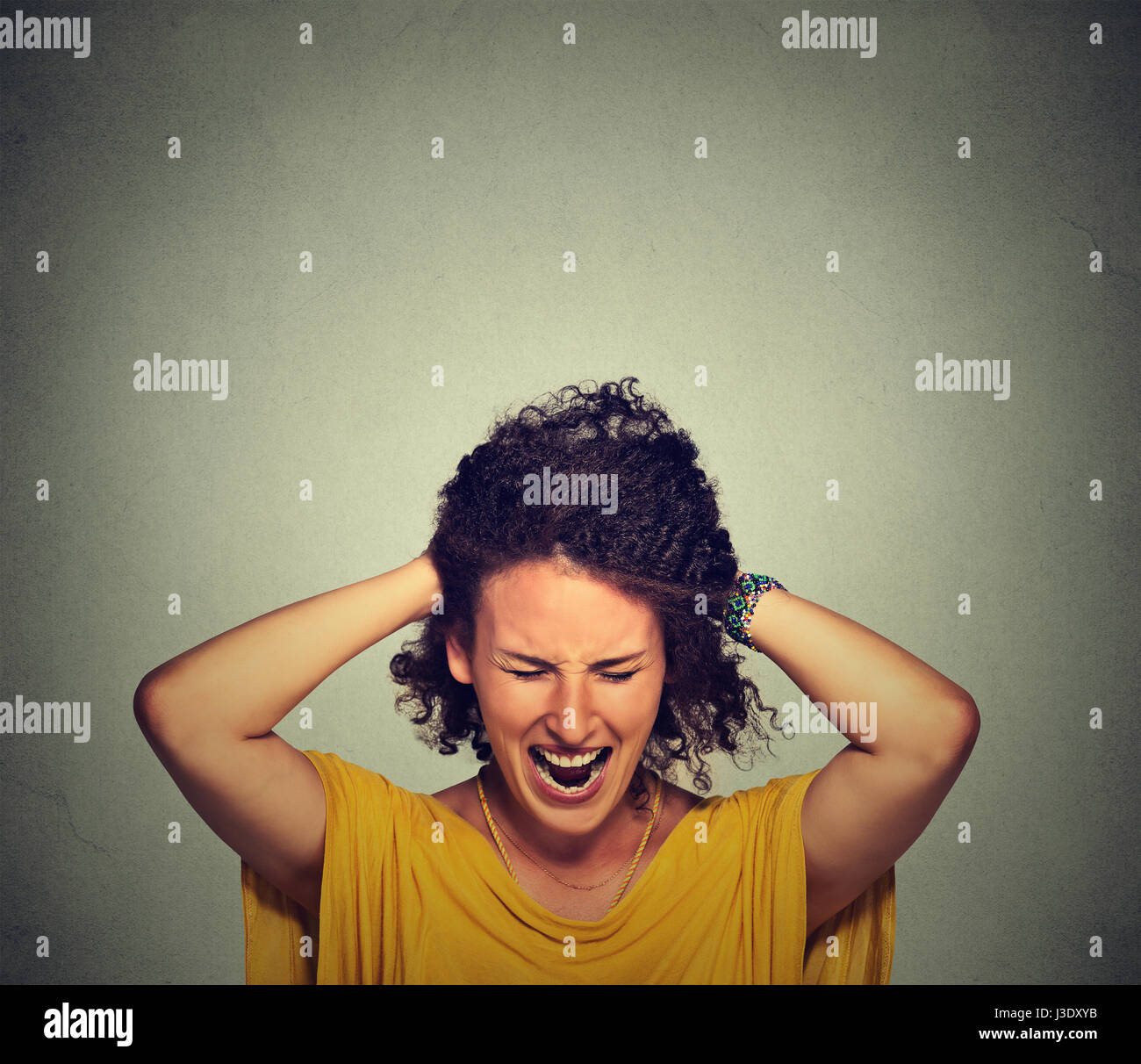 Stress. Woman stressed is going crazy pulling her hair in frustration ...