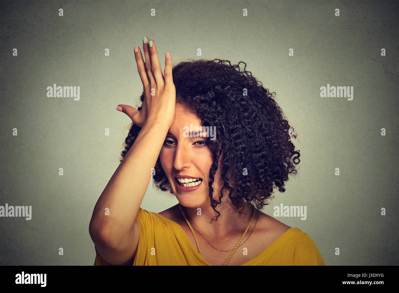 Closeup portrait middle age woman slapping hand on head to say duh made ...