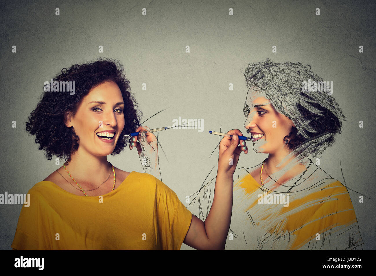 Create yourself, your image concept. Attractive young woman drawing a ...