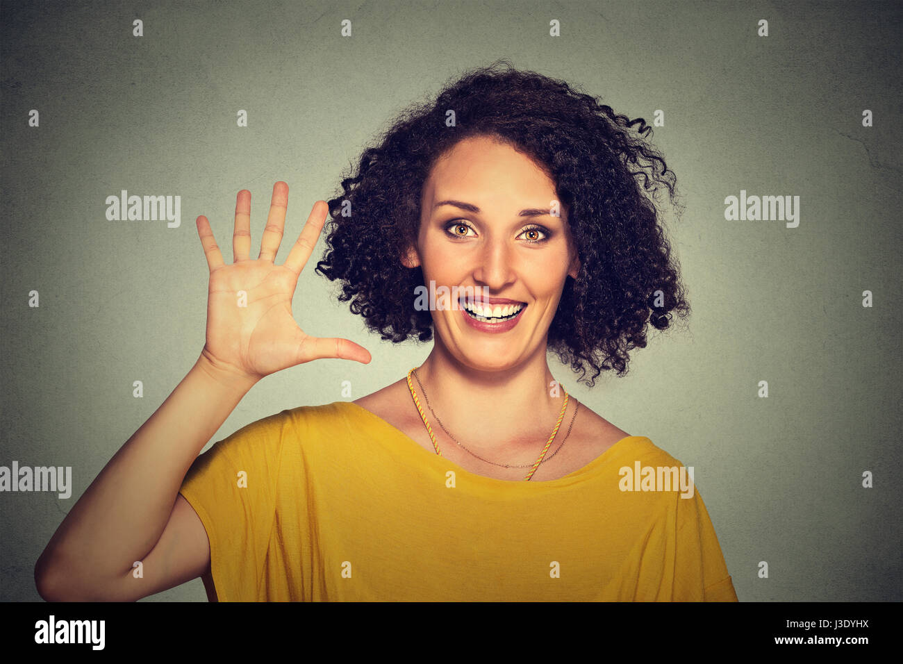 Smiling woman making high five with her hand Stock Photo - Alamy