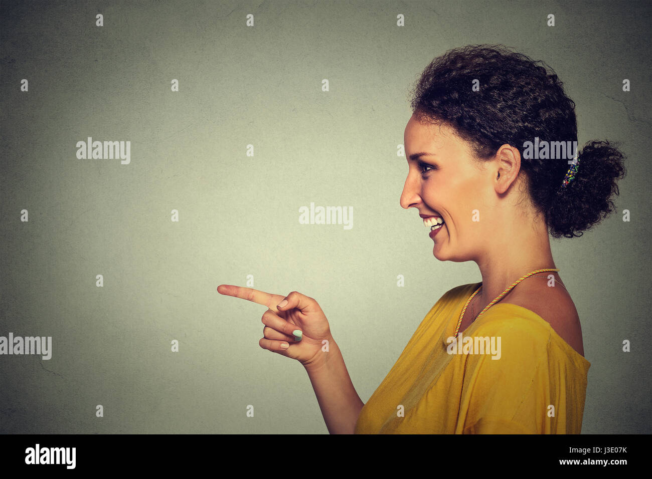 Closeup side view profile portrait of attractive woman pointing and ...
