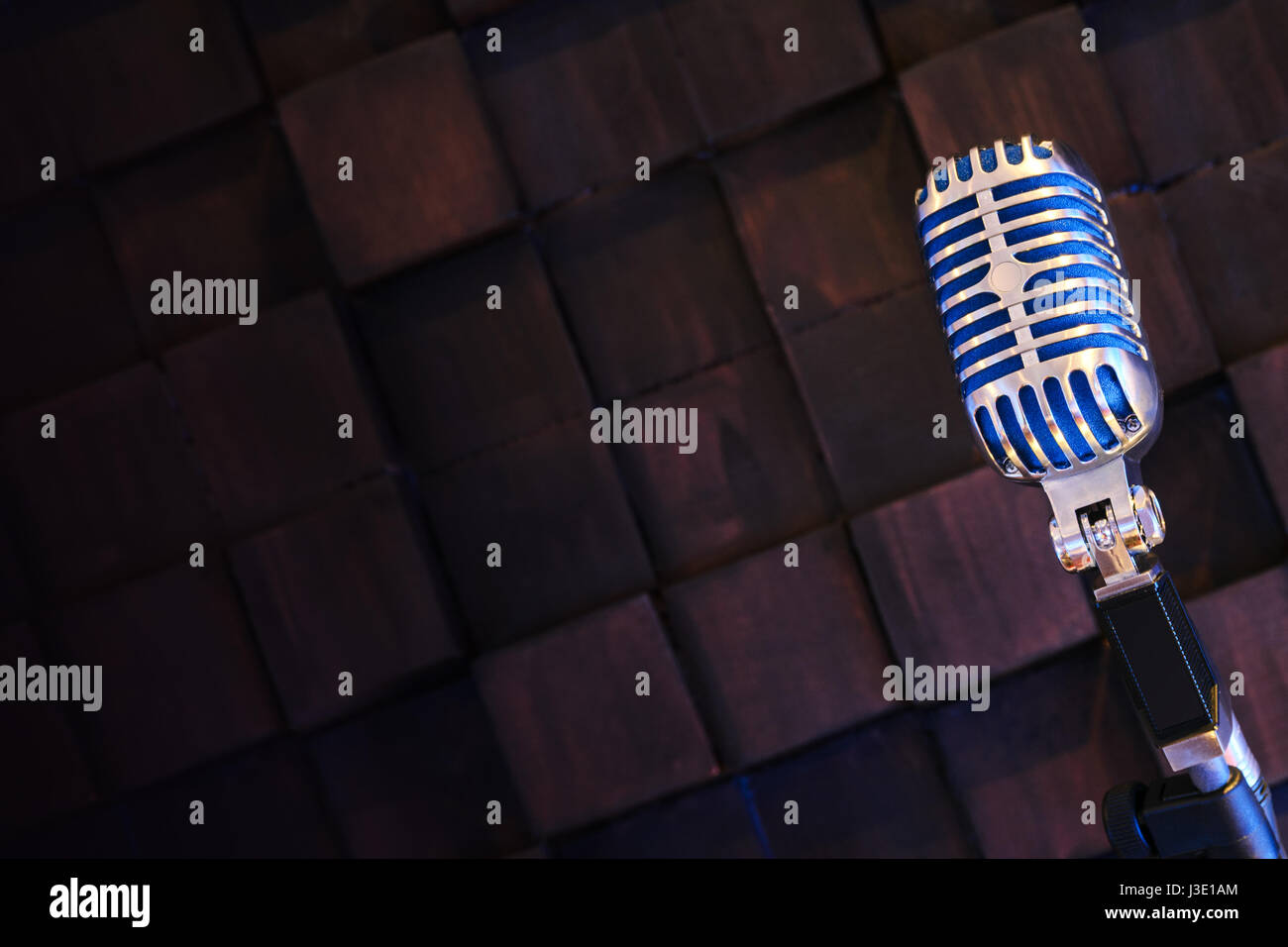 Retro microphone on wood brown background in sound recording room. On ...