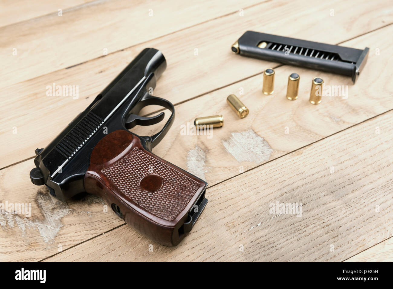 Makarov pistol with bullets on the wooden surface, set Stock Photo - Alamy