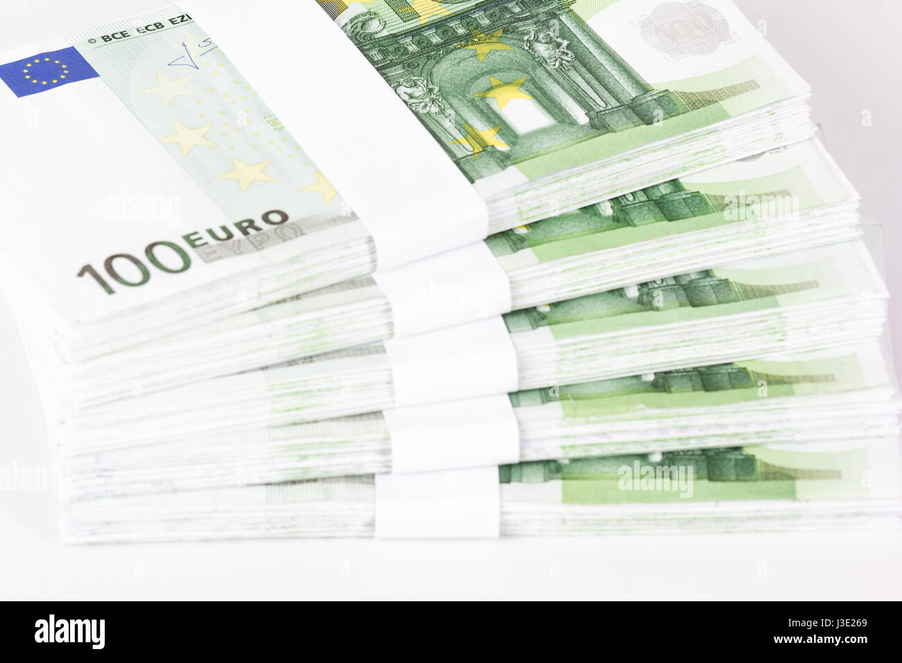 Close-up of Stacks of 100 Euro Banknotes isolated on white background ...