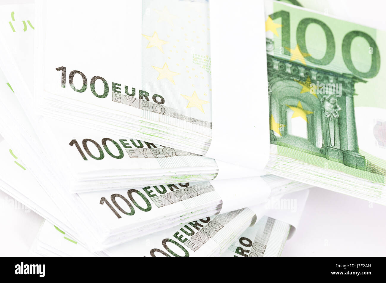 Close-up of Stacks of 100 Euro Banknotes isolated on white background ...