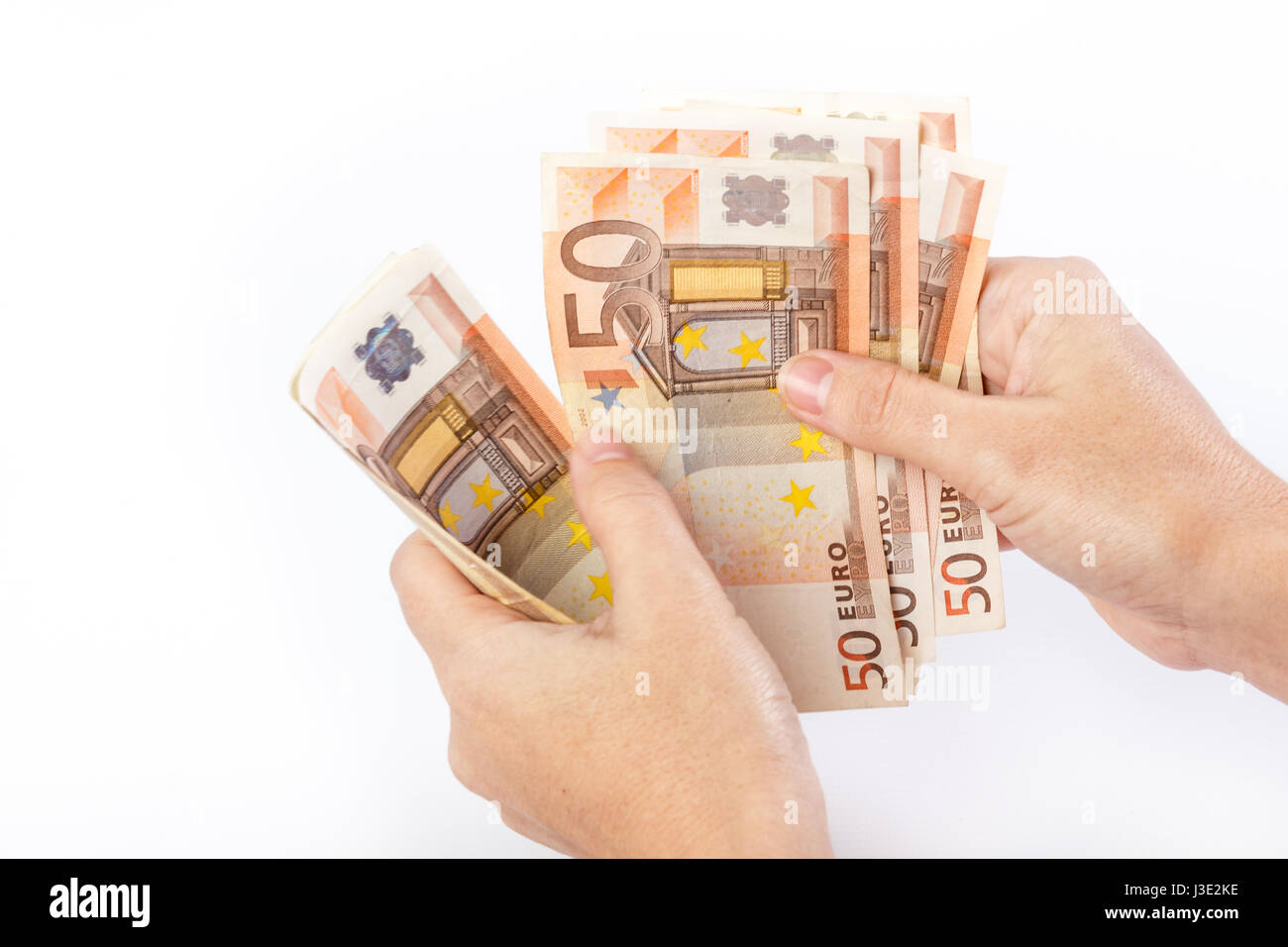 Close up of female hand holding 50 euro banknotes isolated on white ...