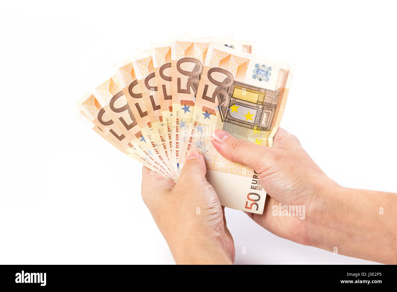 Close up of female hand holding 50 euro banknotes isolated on white ...