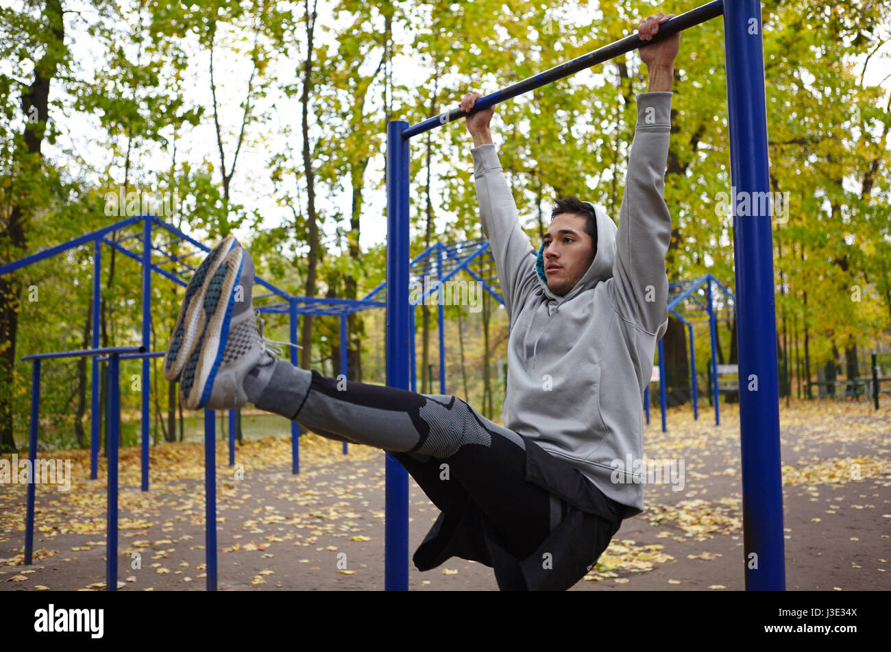 Doing Stomach Workout on Horizontal Bar Stock Photo - Alamy
